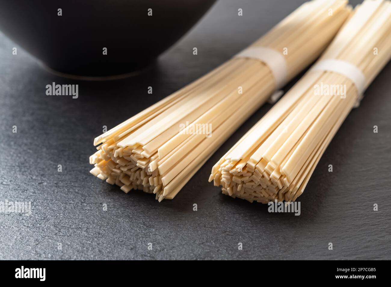Raw udon nudles are ready for cooking. Two bunches of dried japanese ...