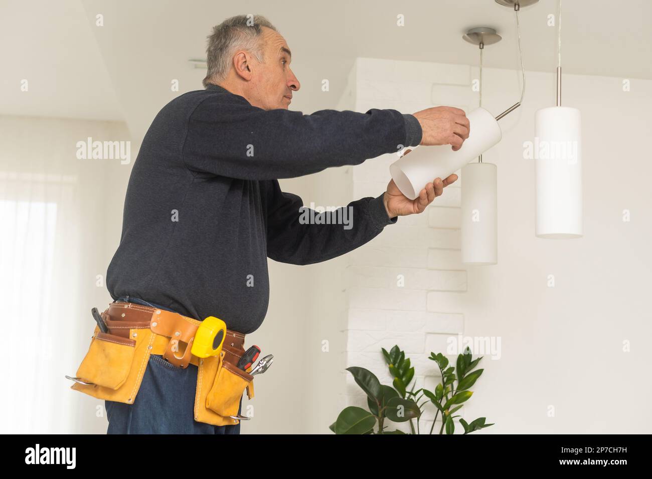 Electrician installs light on ceiling hi-res stock photography and ...