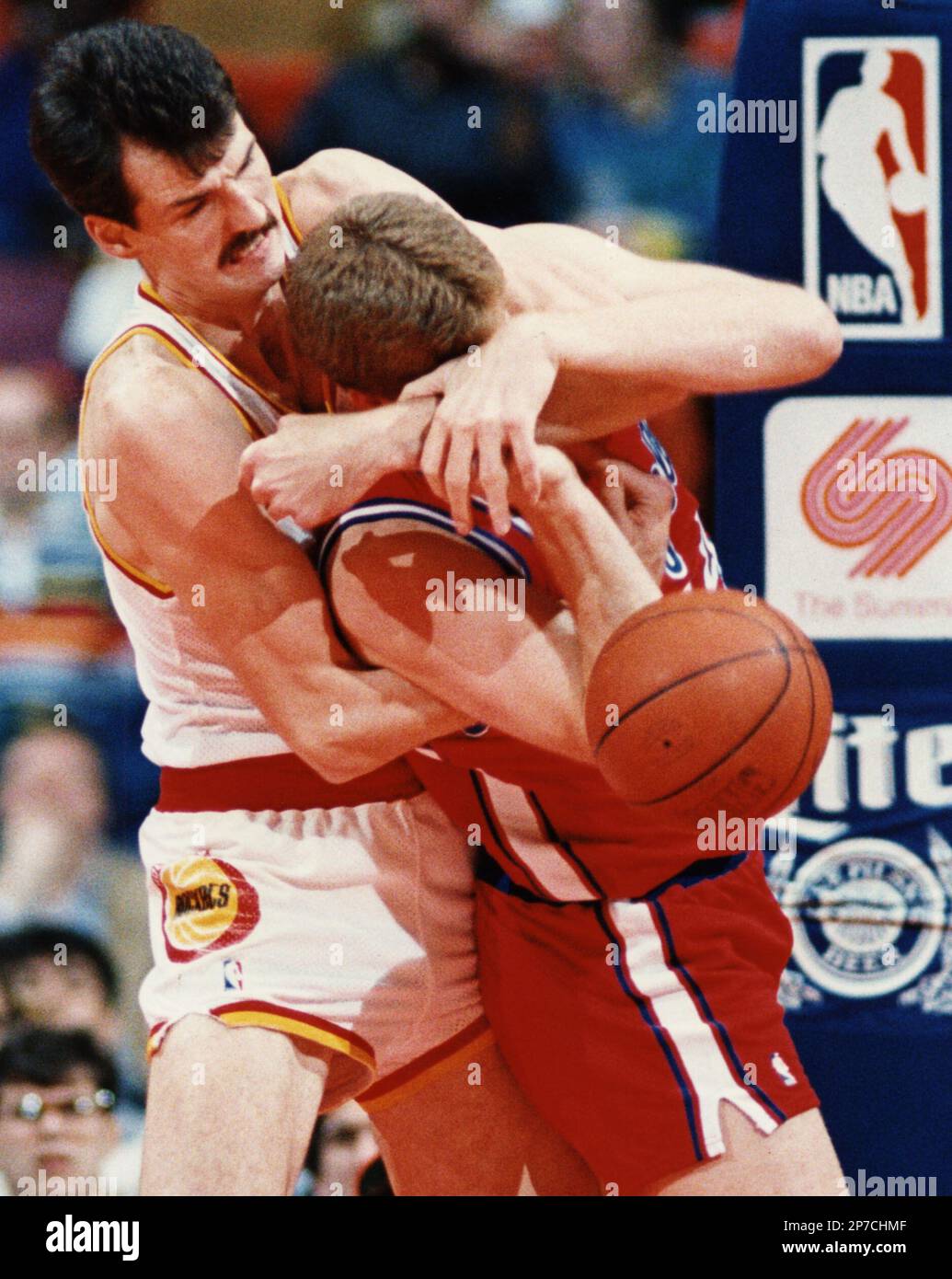 Houston Rockets center Chuck Nevitt, left, ties up Los Angeles Clippers ...