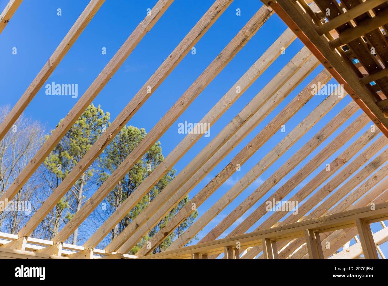 Wooden roof framework was constructed from trusses during construction of new beam stick home ...