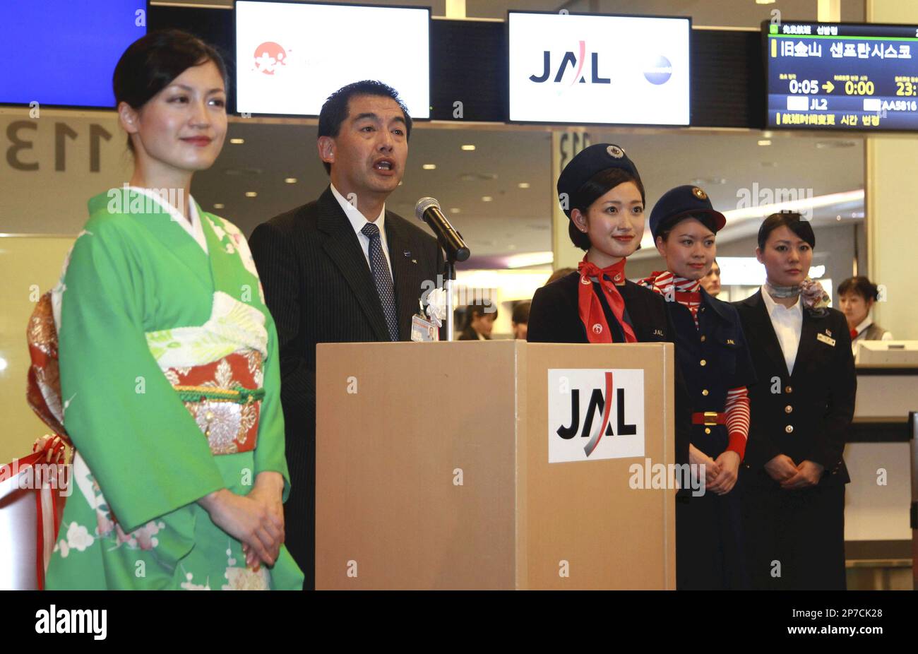 Masaru Onishi with flight attendants, wearing several JAL uniforms in ...