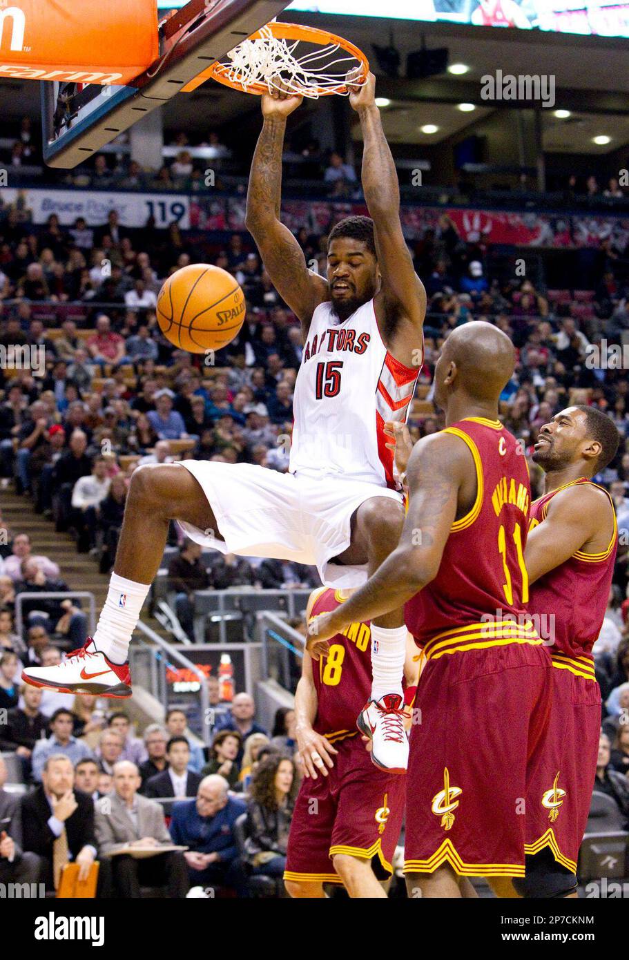 Toronto Raptors' Amir Johnson, left, dunks over Cleveland Cavaliers ...