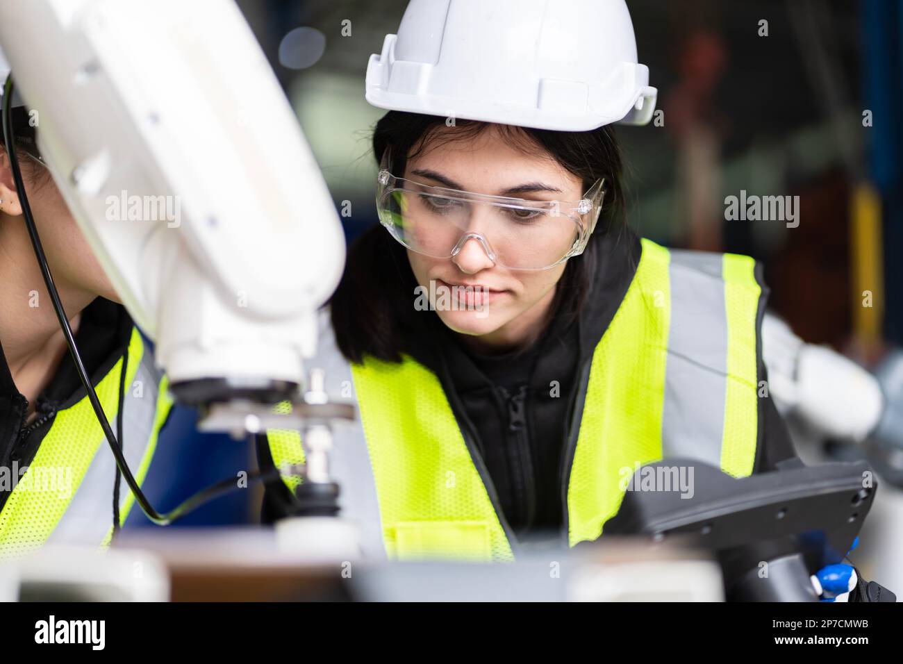 A team of female engineers meeting to inspect computer-controlled steel ...