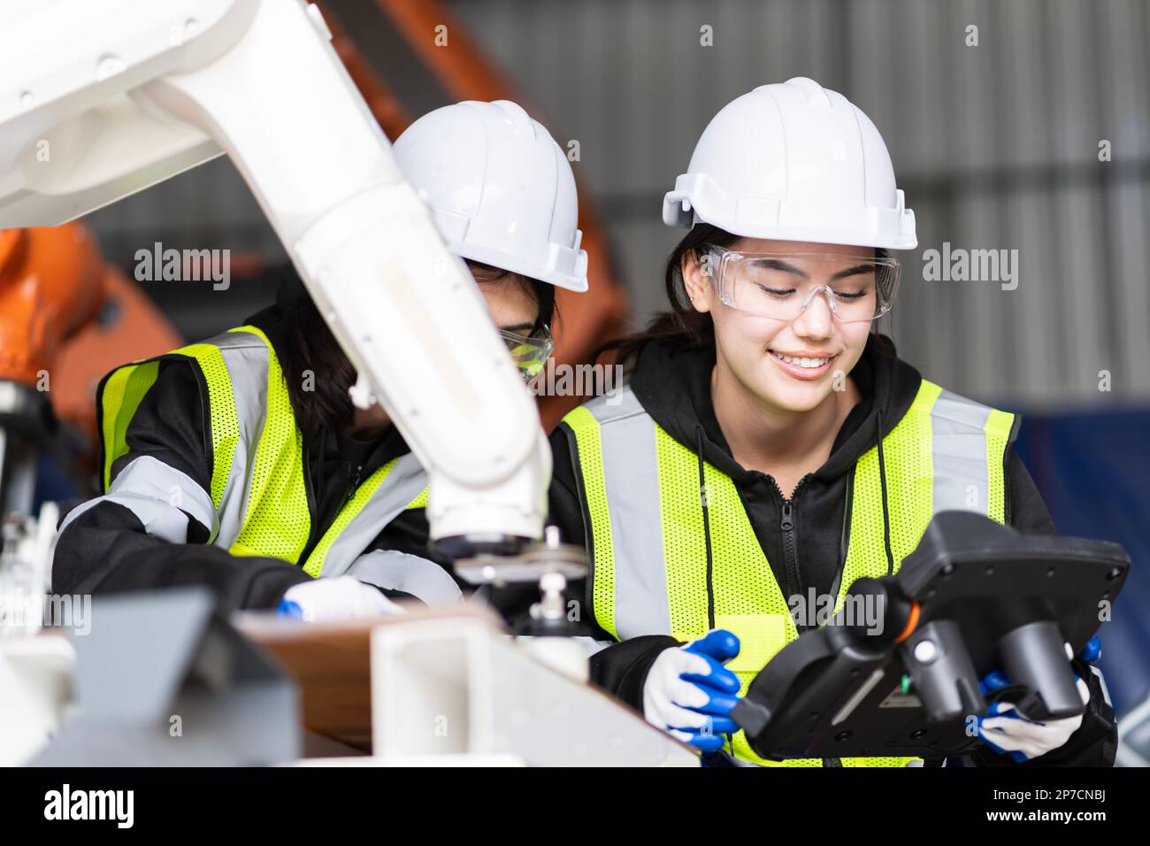 A team of female engineers meeting to inspect computer-controlled steel ...