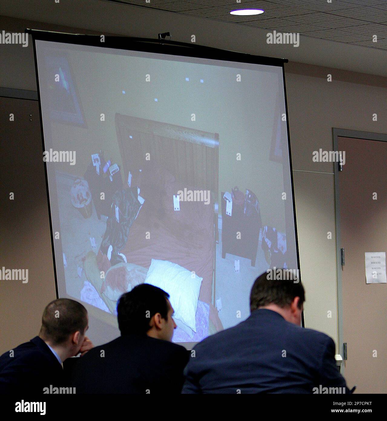 Steven Spader, left, looks at an evidence photo of Kimberly Cates' bed ...