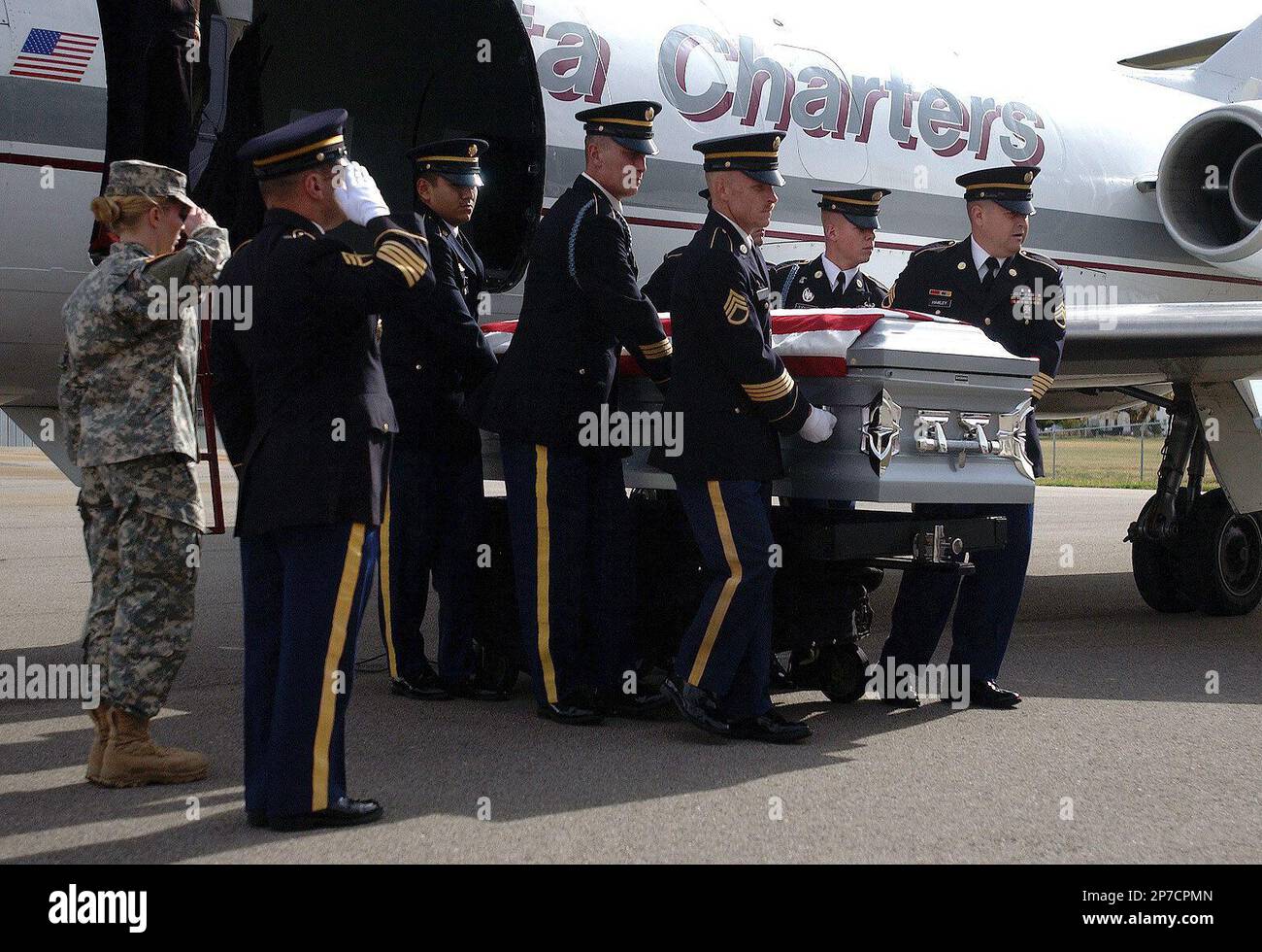 A military honor guard carries the casket of 28-year-old Army Staff Sgt ...