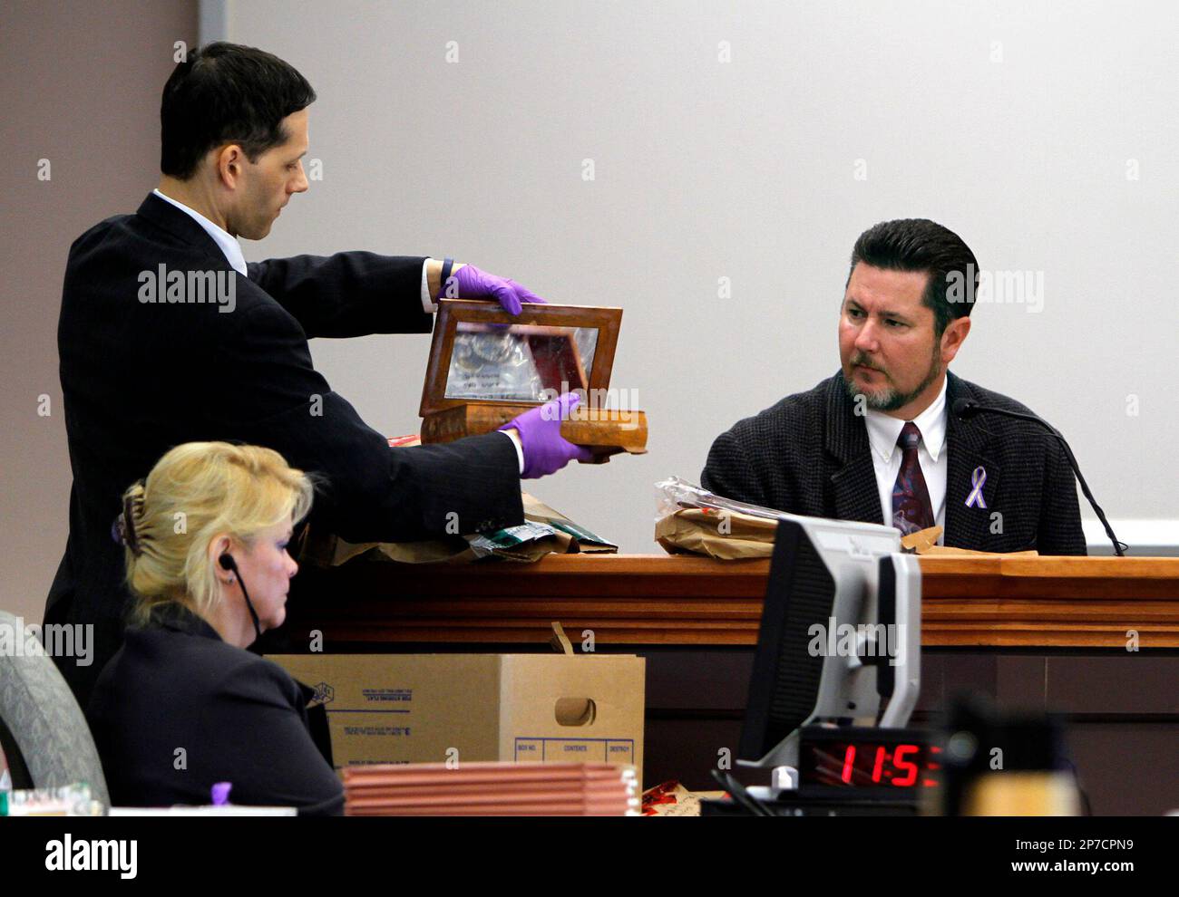 Prosecuting attorney Jeff Strelzin shows David Cates a jewelry box he ...