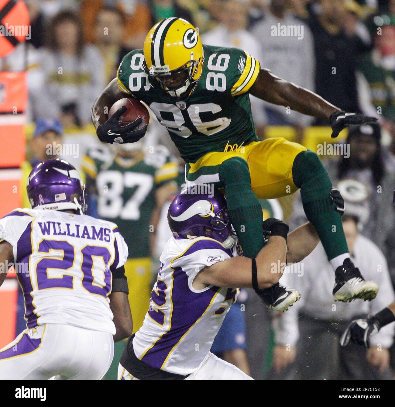 Minnesota Vikings' Chad Greenway and Madieu Williams (20) tackle Green ...