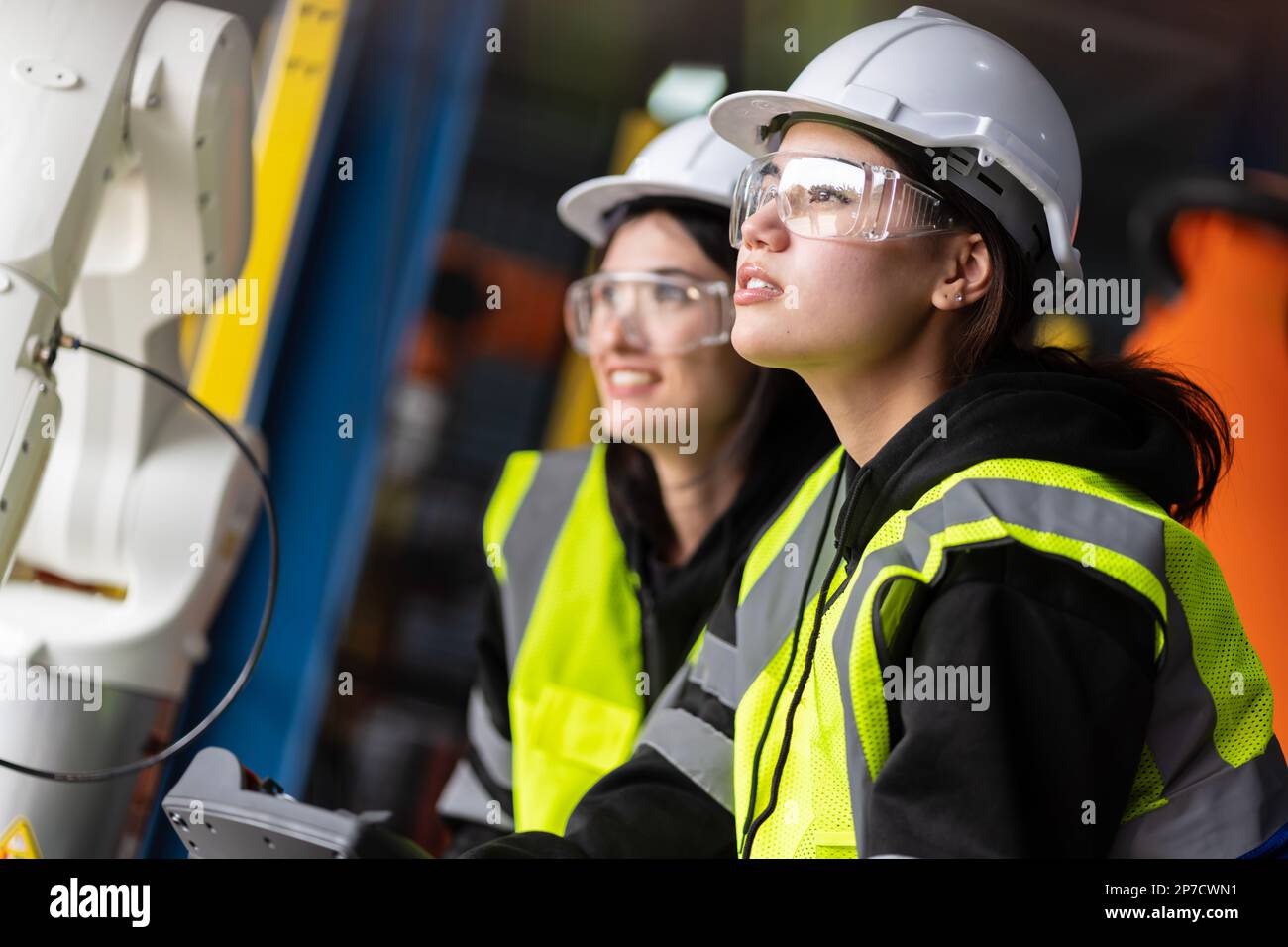 A team of female engineers meeting to inspect computer-controlled steel ...
