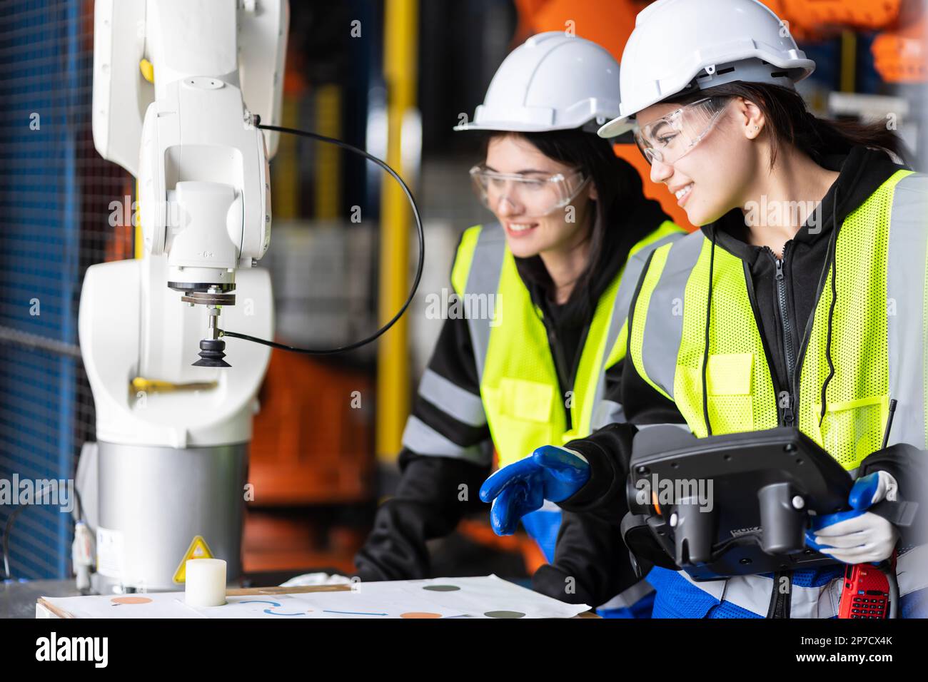 A team of female engineers meeting to inspect computer-controlled steel ...