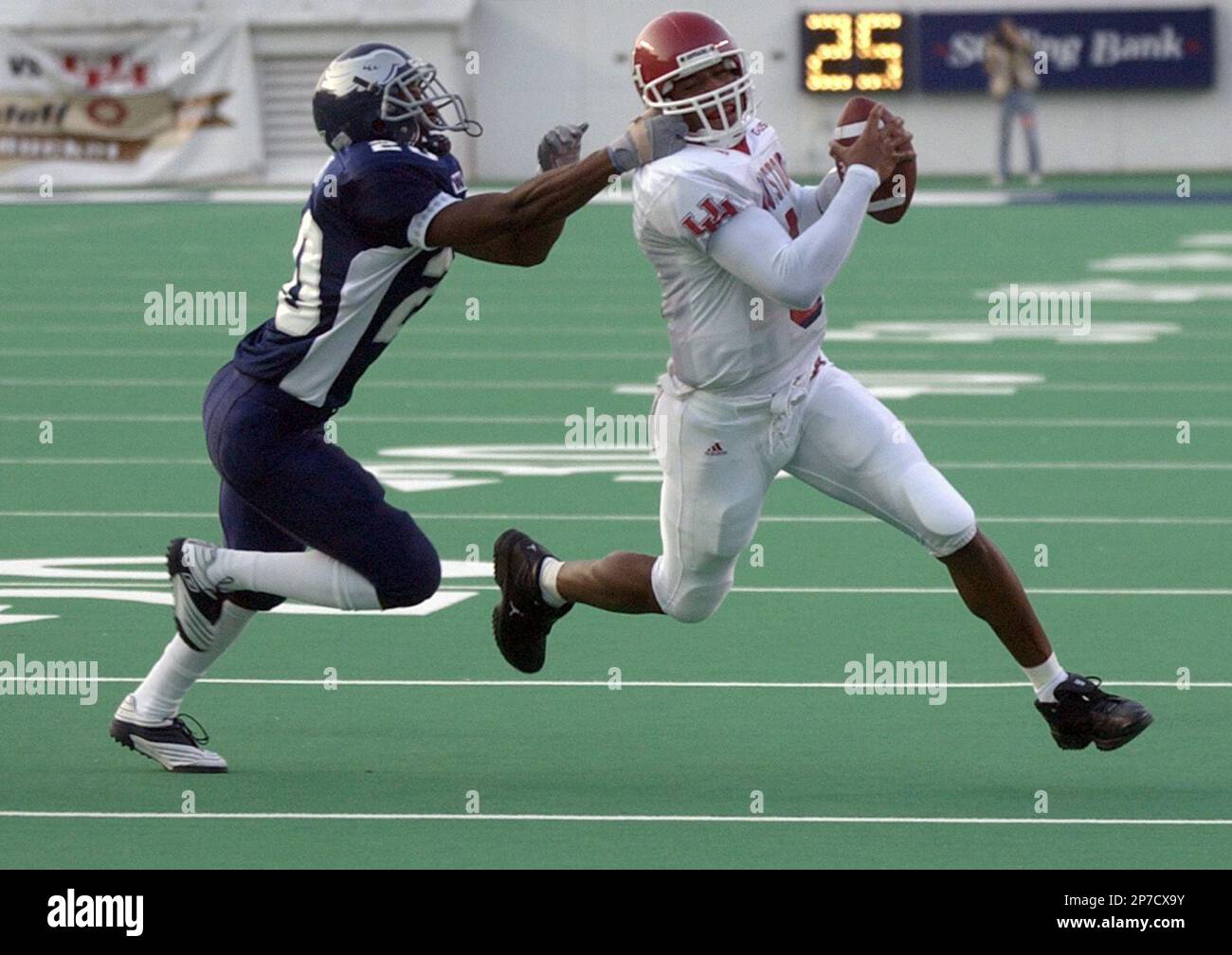 Rice cornerback Patrick Dendy grabs the facemask of UH quarterback ...