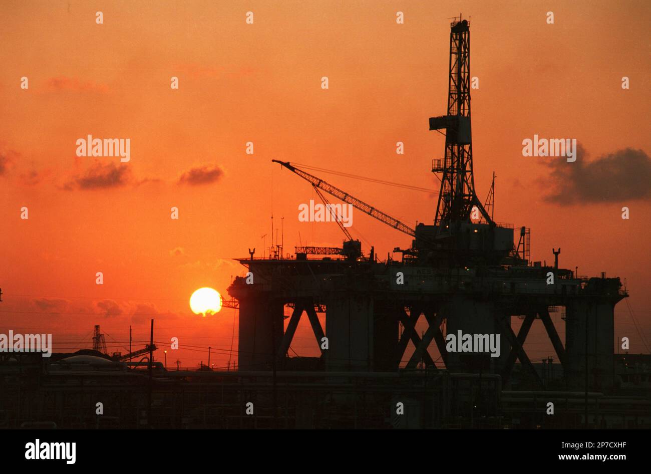 06/06/1996 - Offshore Oil Drilling Platform. The sun sets behind one of ...