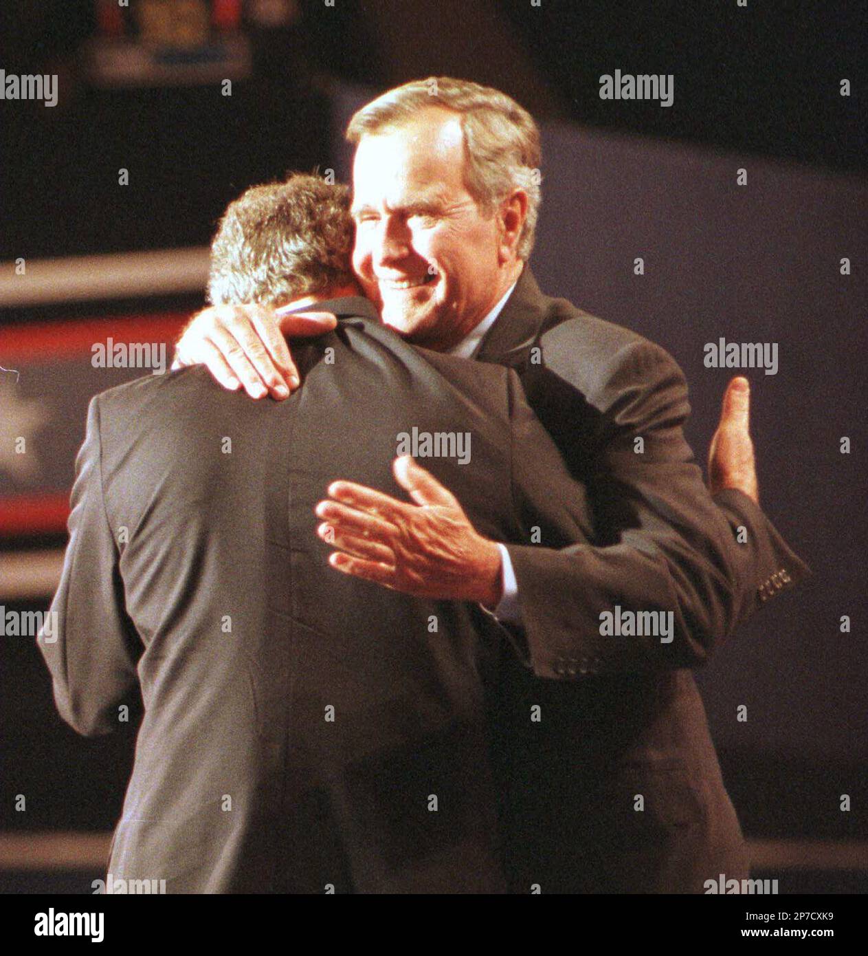 President George Bush hugs his son Gov. George W. Bush prior to ...
