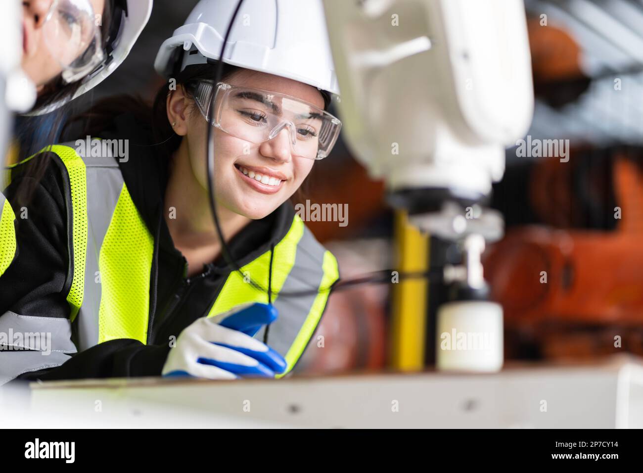 A team of female engineers meeting to inspect computer-controlled steel ...