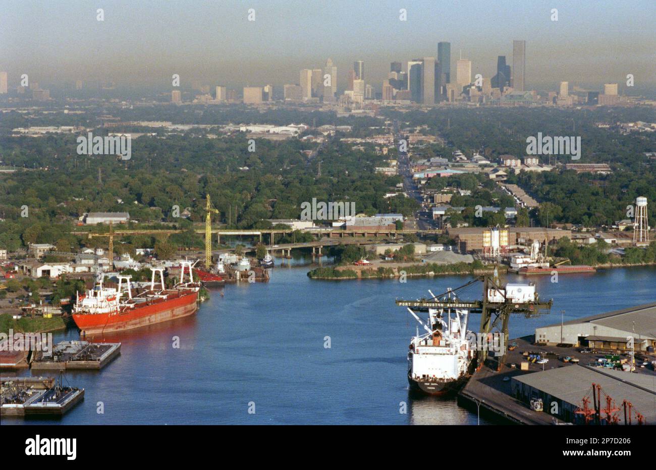 Aerial view of the Houston Ship Channel with the smoggy downtown ...