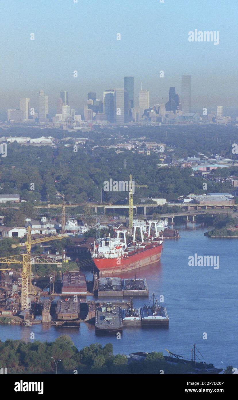 Aerial view of a ship moored in the ship channel with the downtown ...