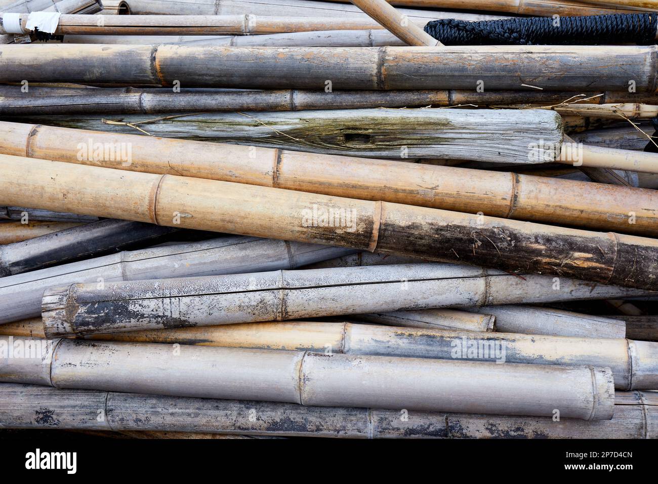 Pile of weathered bamboo poles Stock Photo - Alamy