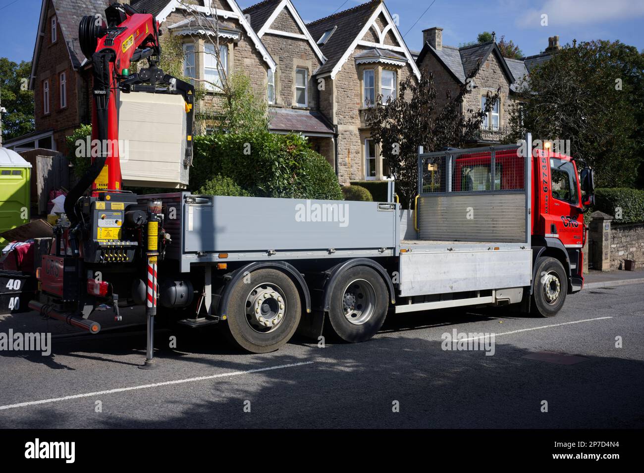 A flatbed lorry delivering construction materials to a site Stock Photo ...