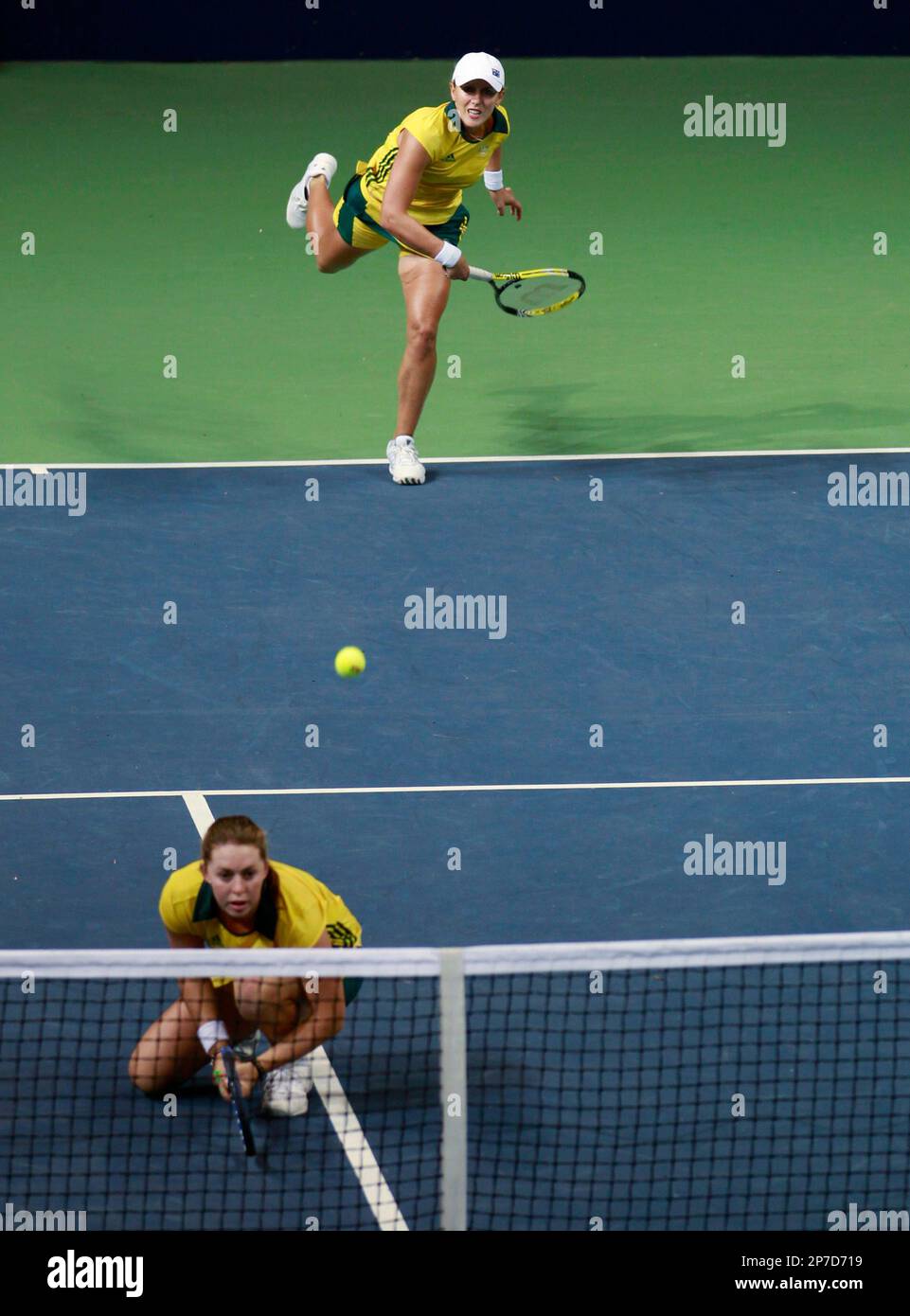 Australia's Anastasia Rodionova, top, serves as partner Sally Peers ...