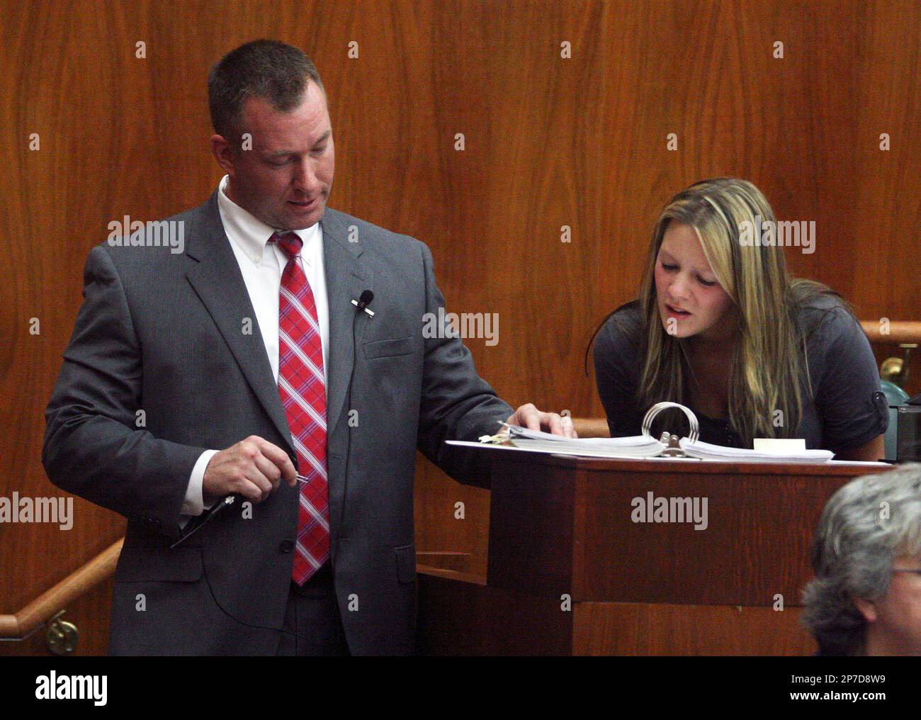 Deputy District Attorney Matt Kemmy shows Jamie Lewis a transcript ...