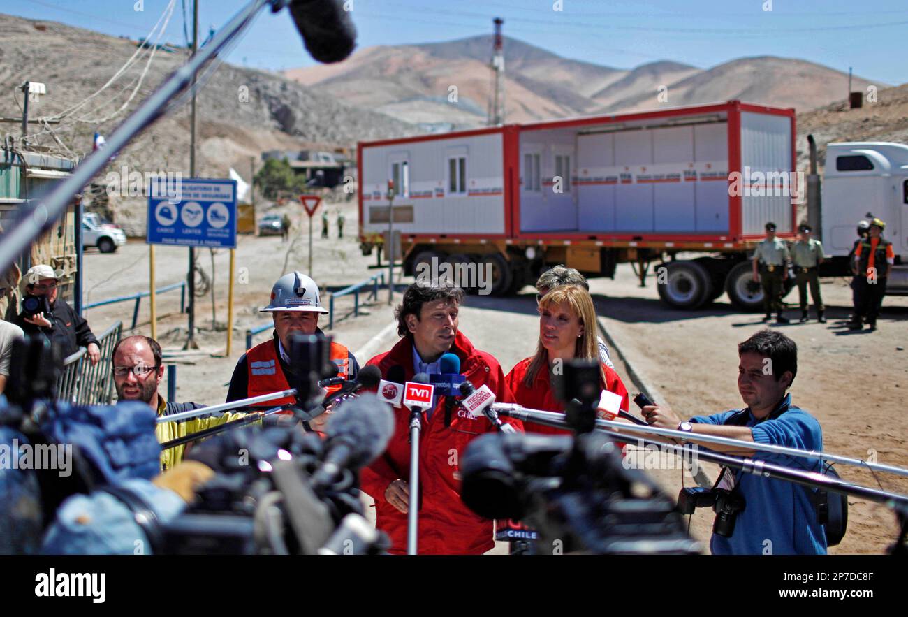 Chile's Mining Minister Laurence Golborne, center, speaks to the media ...
