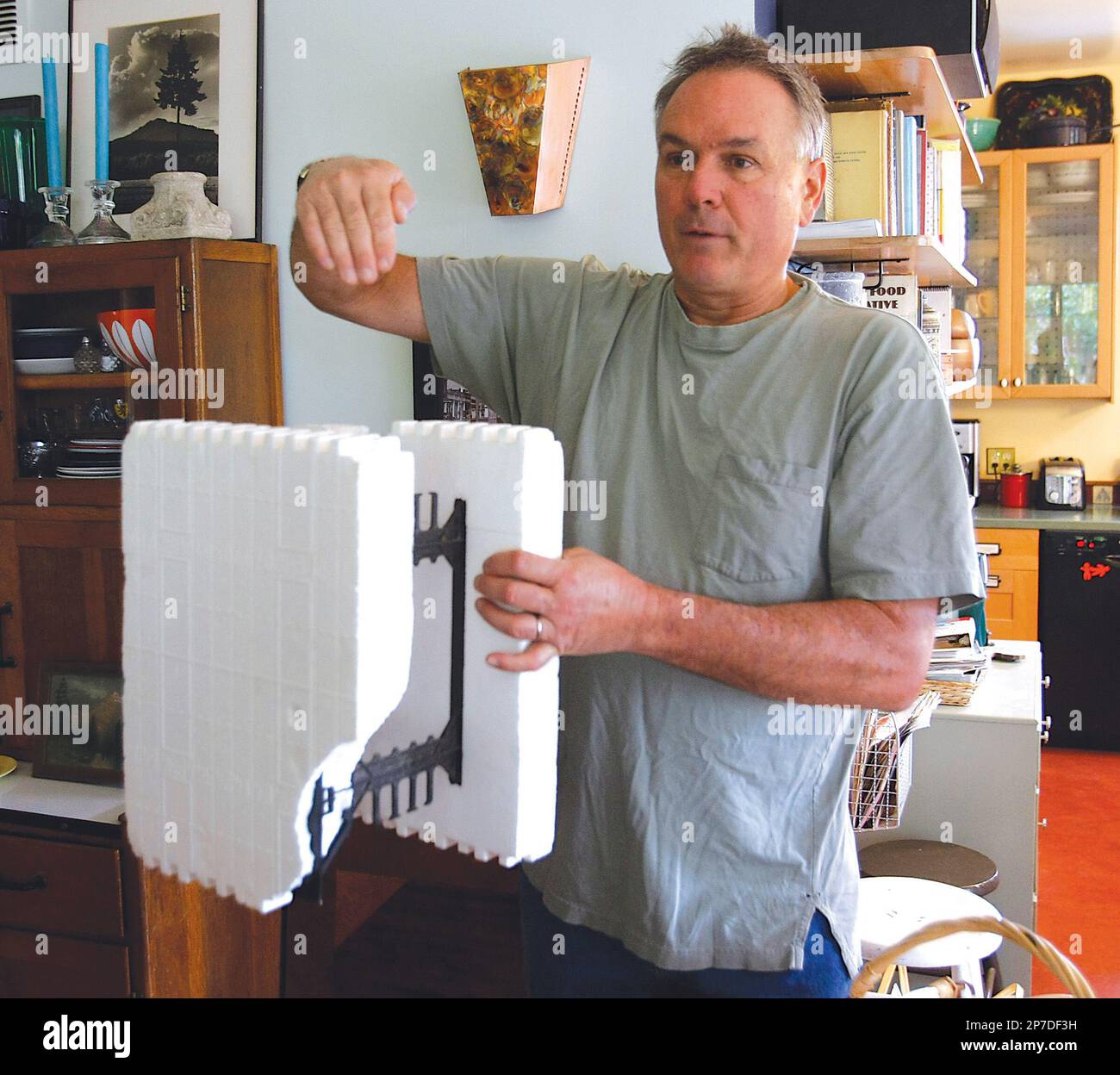 Evan Barnes holds a sample of the insulated concrete forms he used in ...