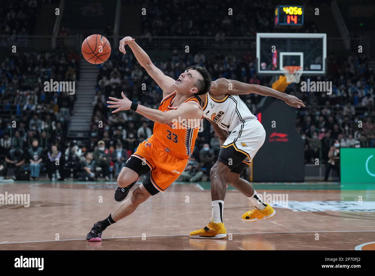 Shenyang. 8th Mar, 2023. Luo Hanchen (L) of Shanghai Sharks competes ...