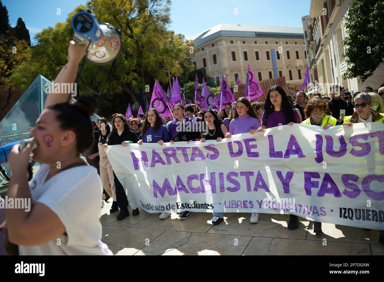 A woman is seen shouting on a megaphone as others students take part ...