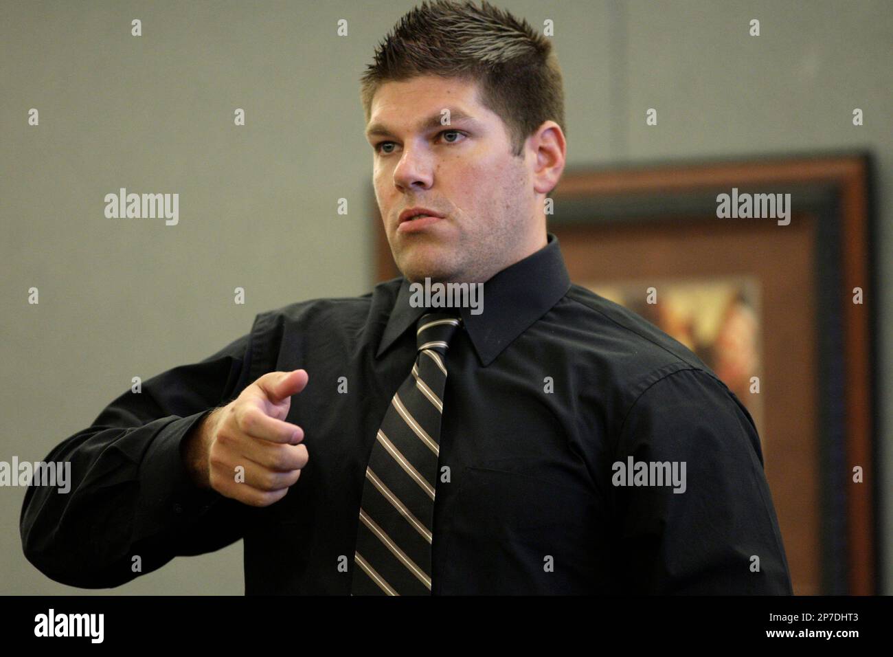 Shai Lierley, a Costco loss prevention supervisor, demonstrates on how ...