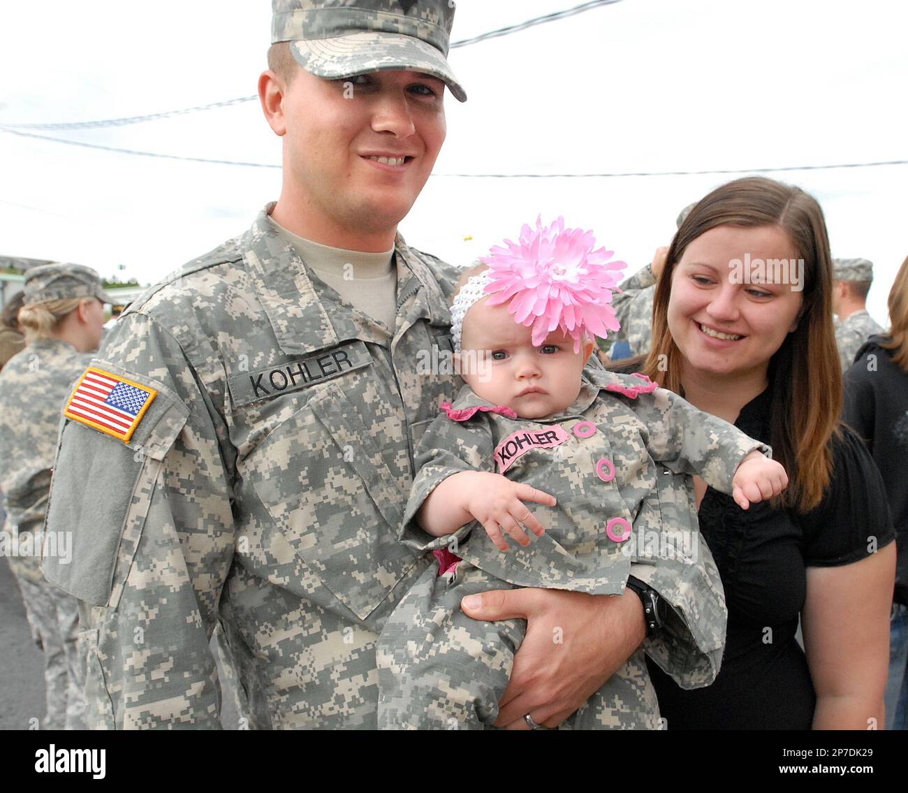 Spc. Maxwell Kohler of the Idaho National Guard, left, cradles his 6 ...
