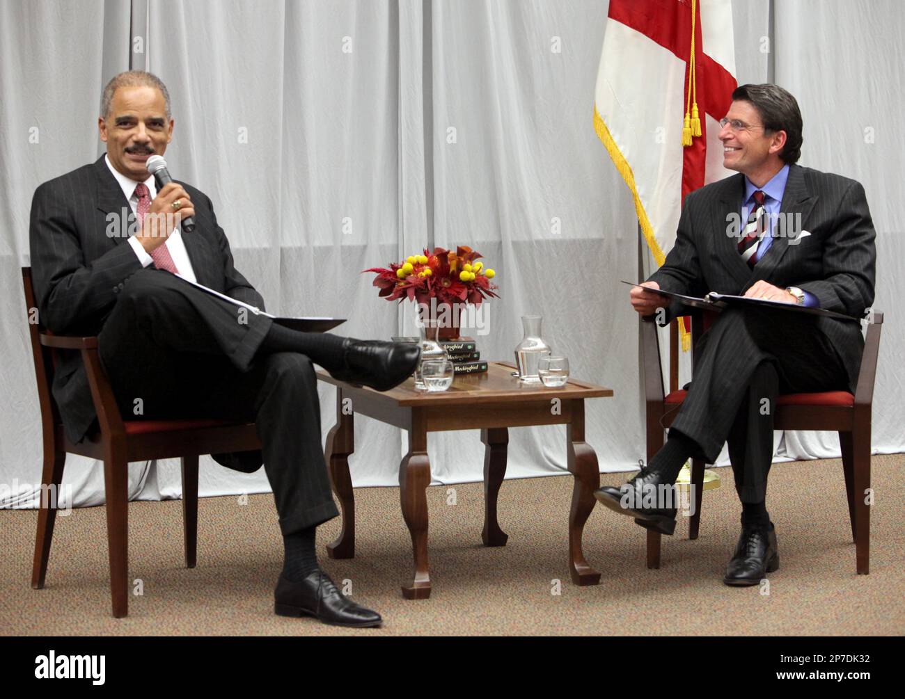 U.S. Attorney General Eric Holder, left, answers questions from ...