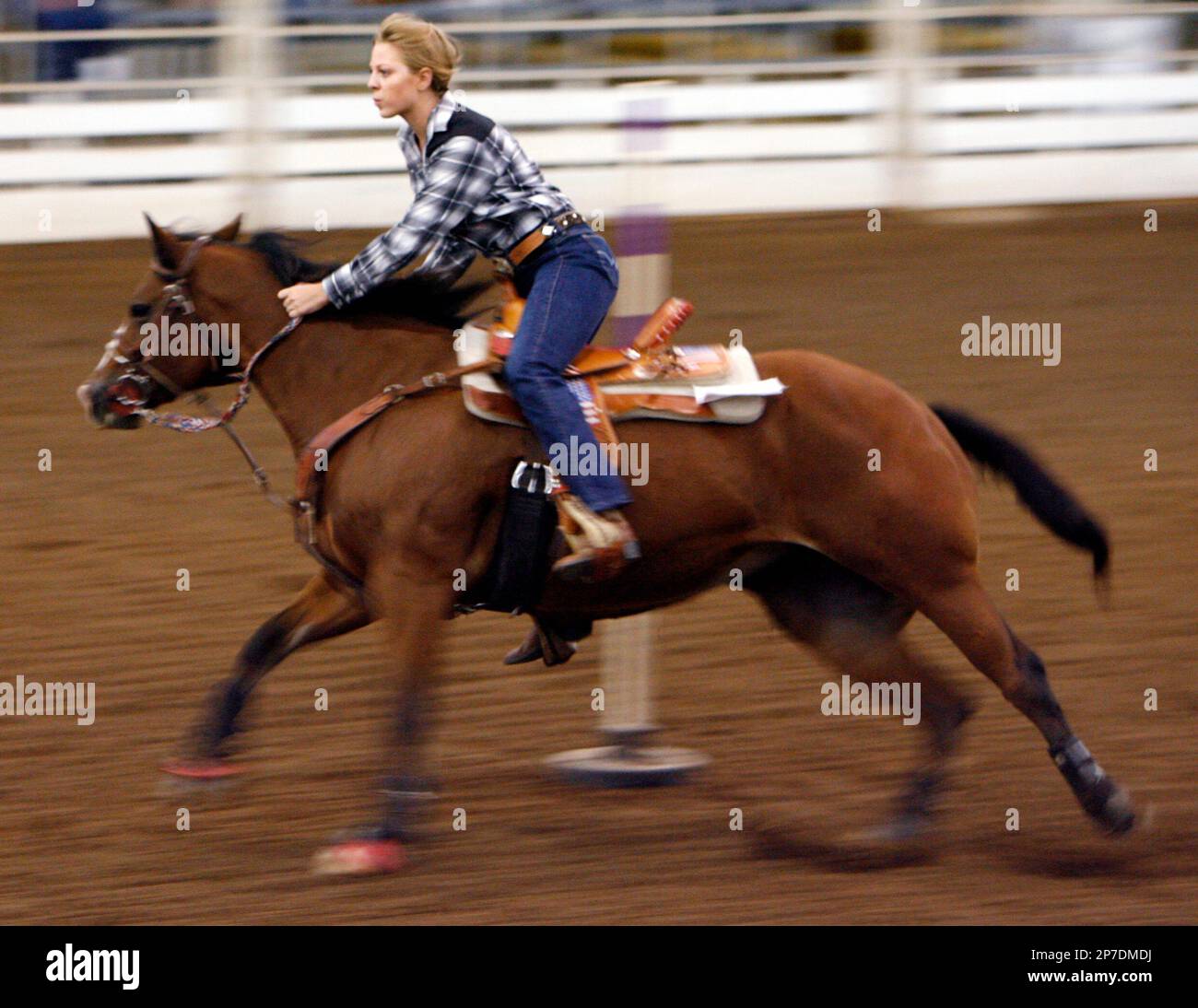 Kayla Sims competes in pole bending aboard Regers Baywatch as part of ...