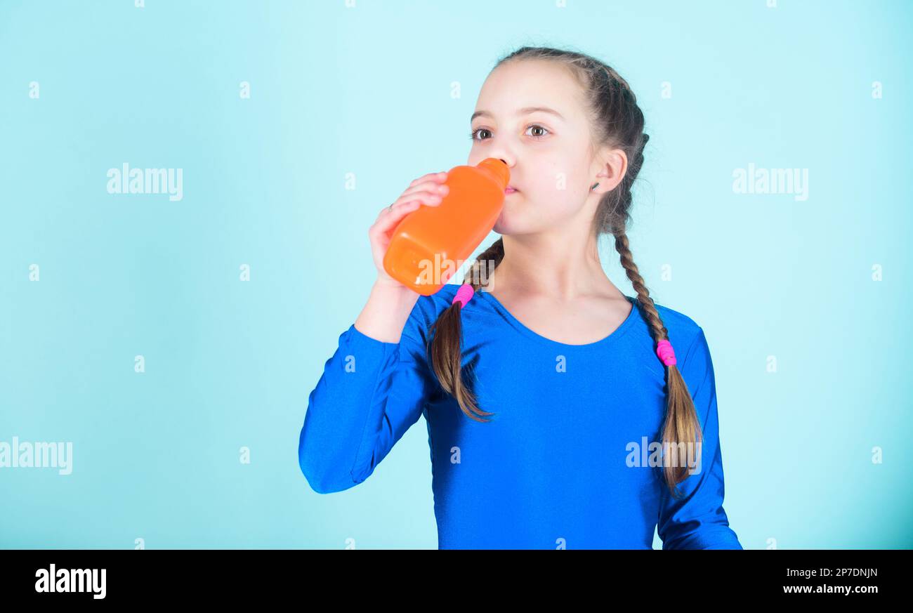 Little girl drink water from bottle. Happy child sportsman. Fitness and diet. Energy. Relax ...