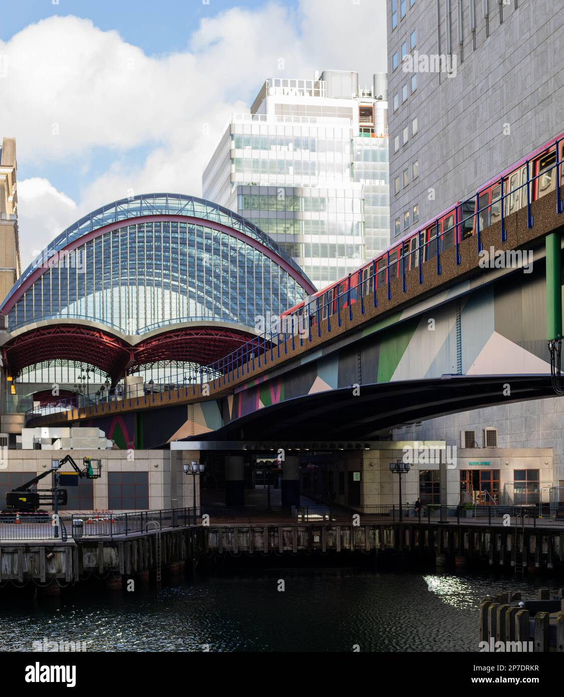 A train enters Canary Wharf DLR station. The station features two ...