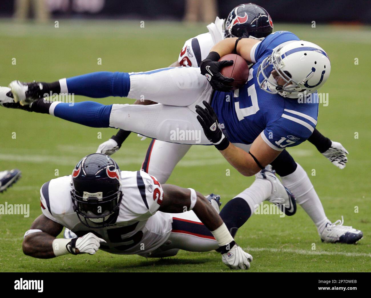 Indianapolis Colts' Austin Collie (17) is upended by Houston Texans ...