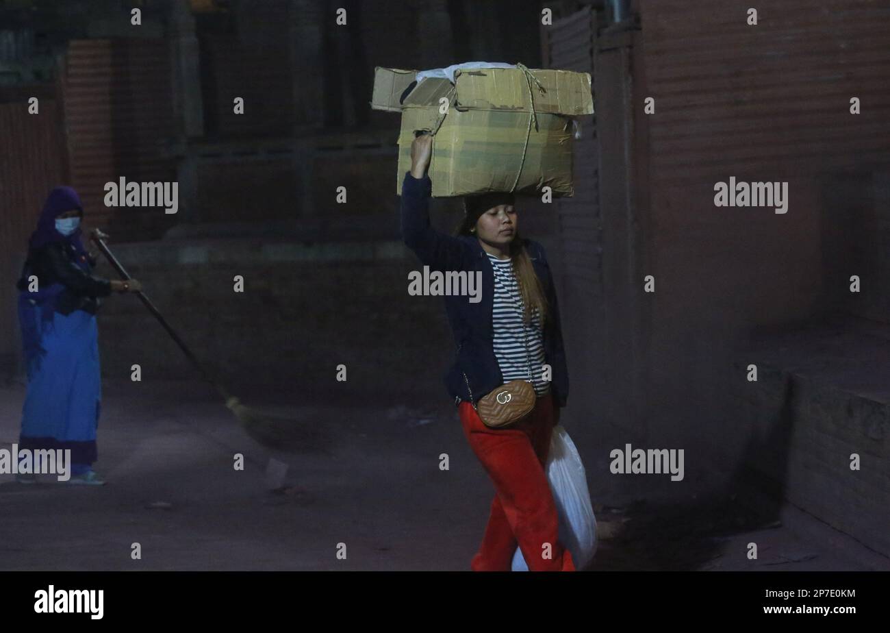 Kathmandu, Bagmati, Nepal. 8th Mar, 2023. A street vendor moves forward to sell products while a ...