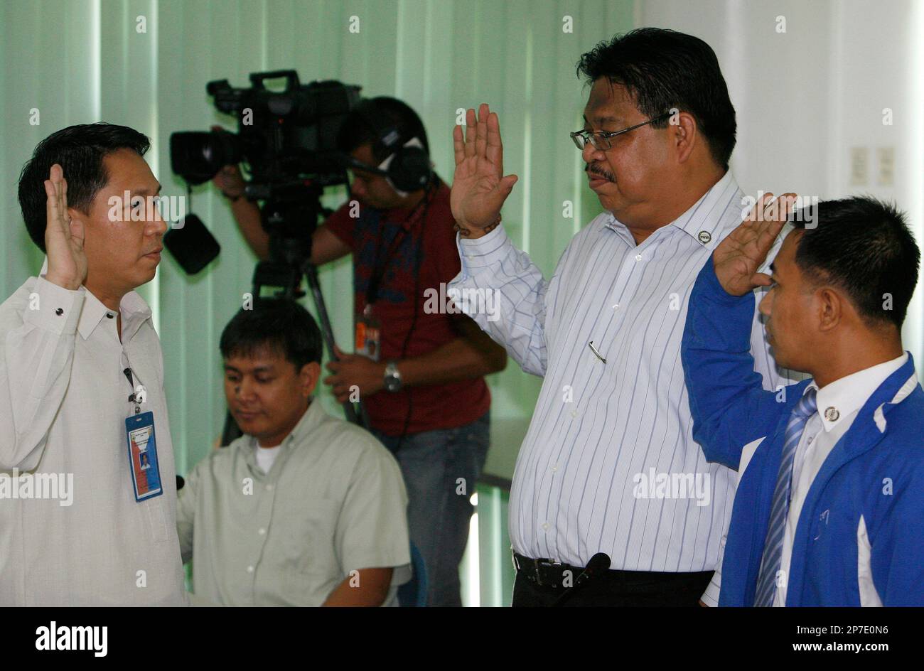 Radio Mindanao Network (RMN) anchor Michael Rogas, right, who ...