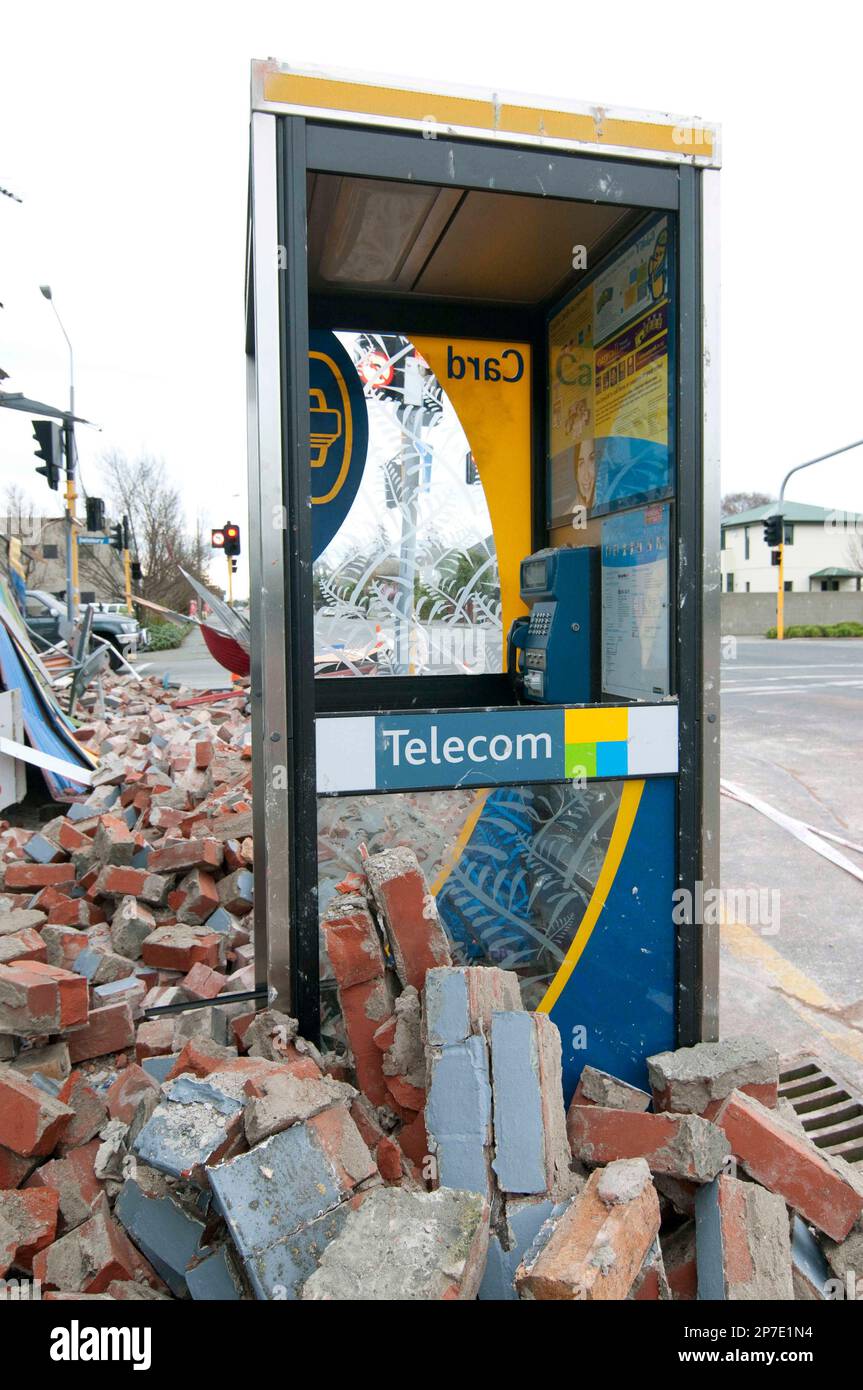 Rubble and debris surround a damaged telephone booth following Saturday ...