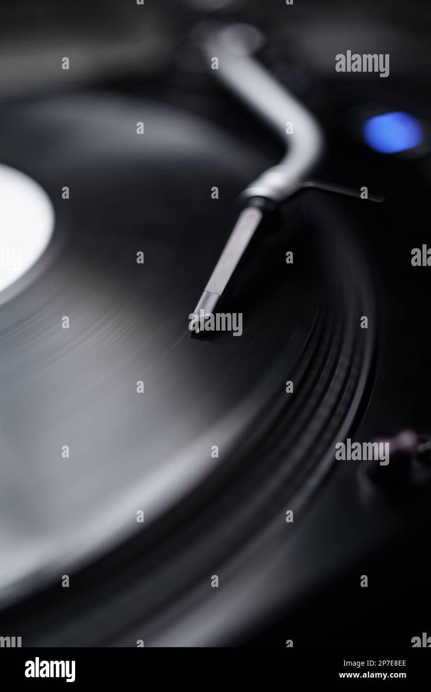 Retro DJ turn table plays vinyl record with music. Turntables needle on ...
