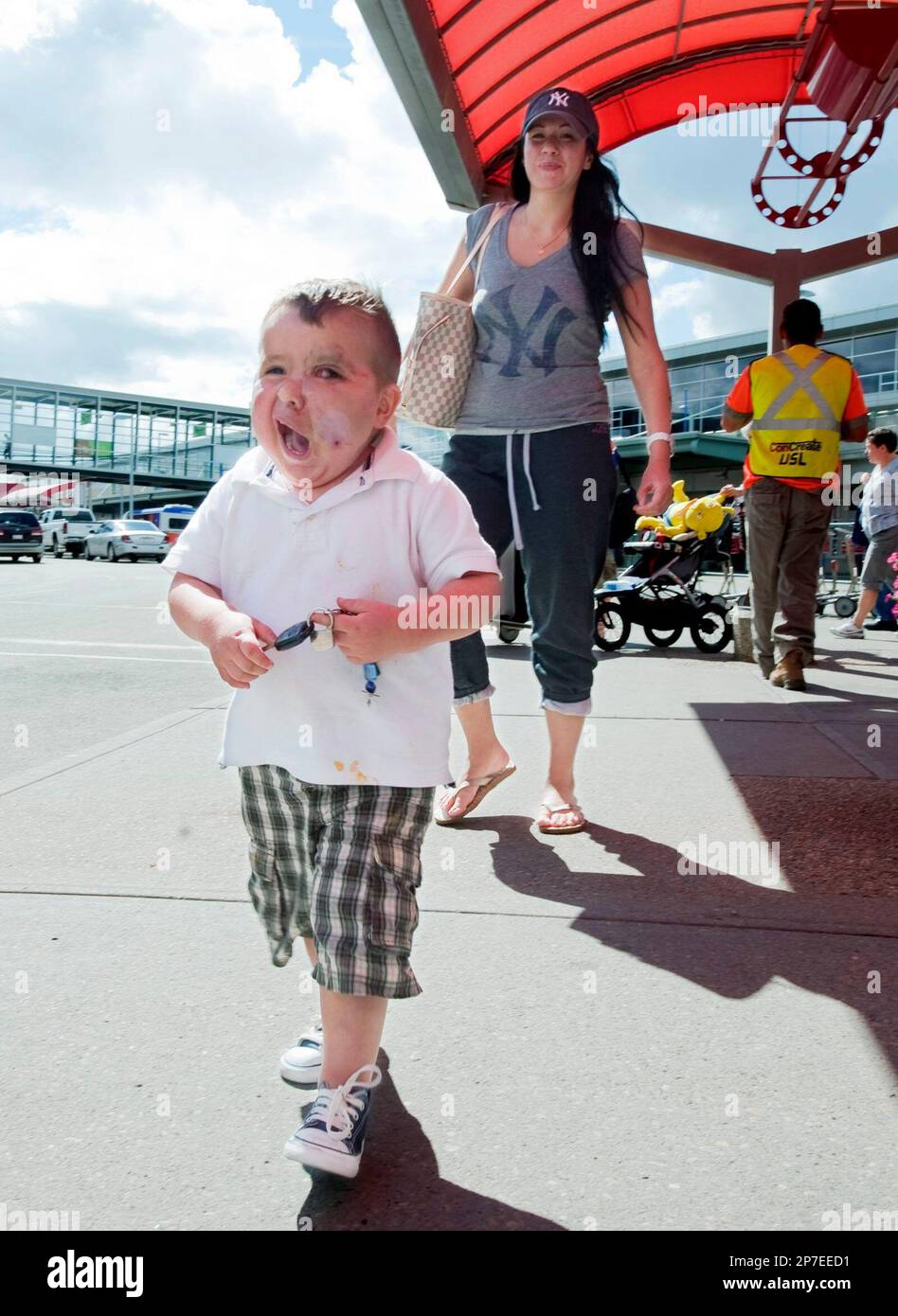 Maddox Flynn, 2, front, walks through the Edmonton International ...
