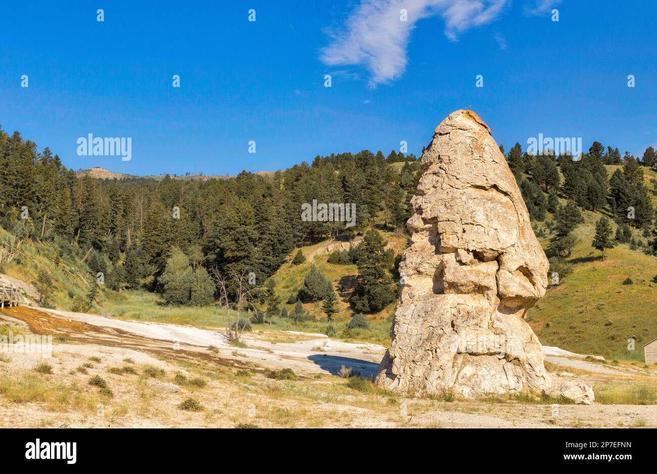 A tall coned rock structure names Liberty Cap at Mammoth Hot Springs in ...