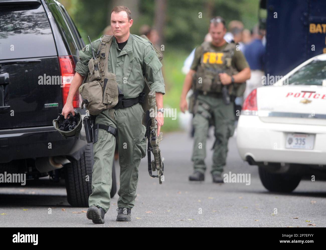 Members of the FBI SWAT team leave the scene where Michael Mara, 53 ...