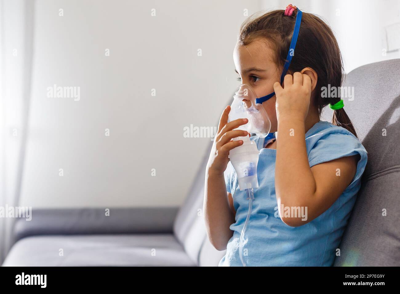 Little girl making inhalation with nebulizer at home. child asthma ...
