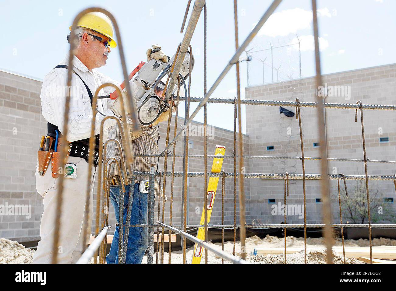 Jose Narvaez, of Magnum Construction, cuts excess rebar from the ...