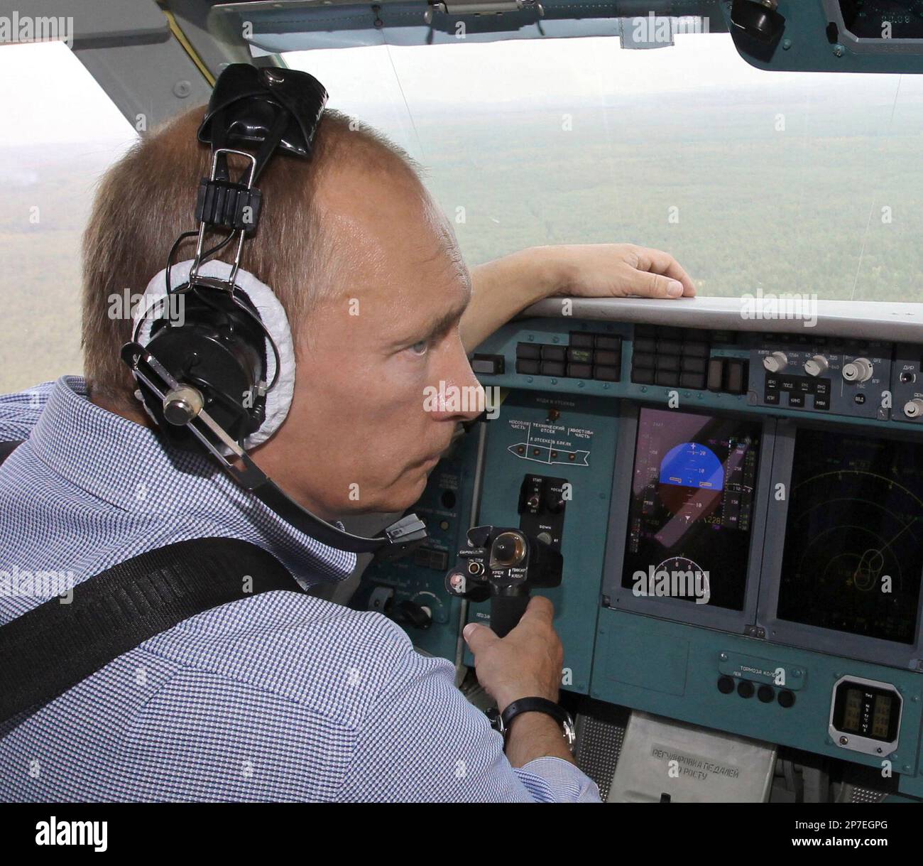 Russian Prime Minister Vladimir Putin sits in the co-pilot's seat at a ...