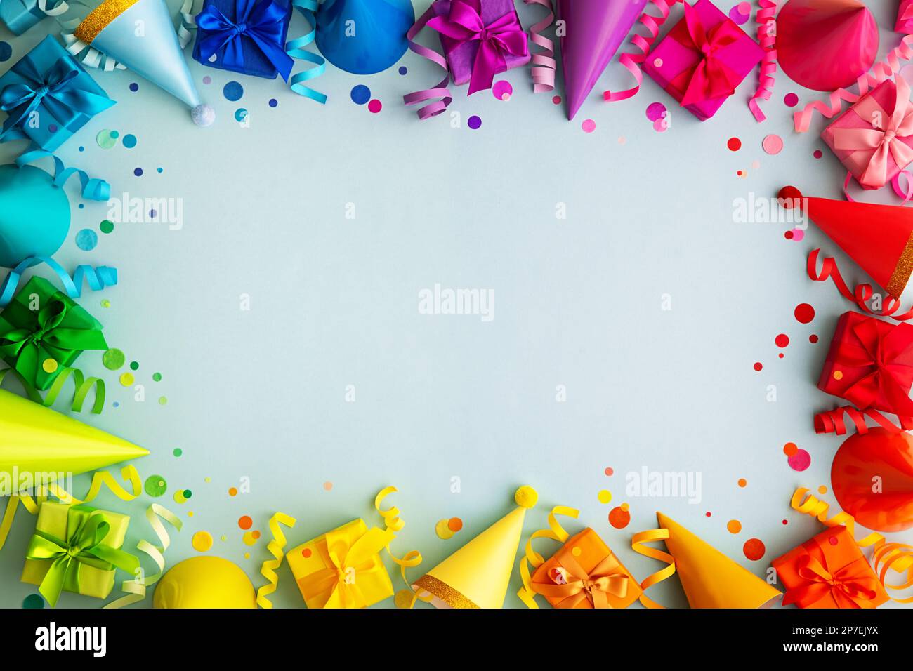Colorful rainbow birthday party border frame background with party hats, birthday gifts and ...