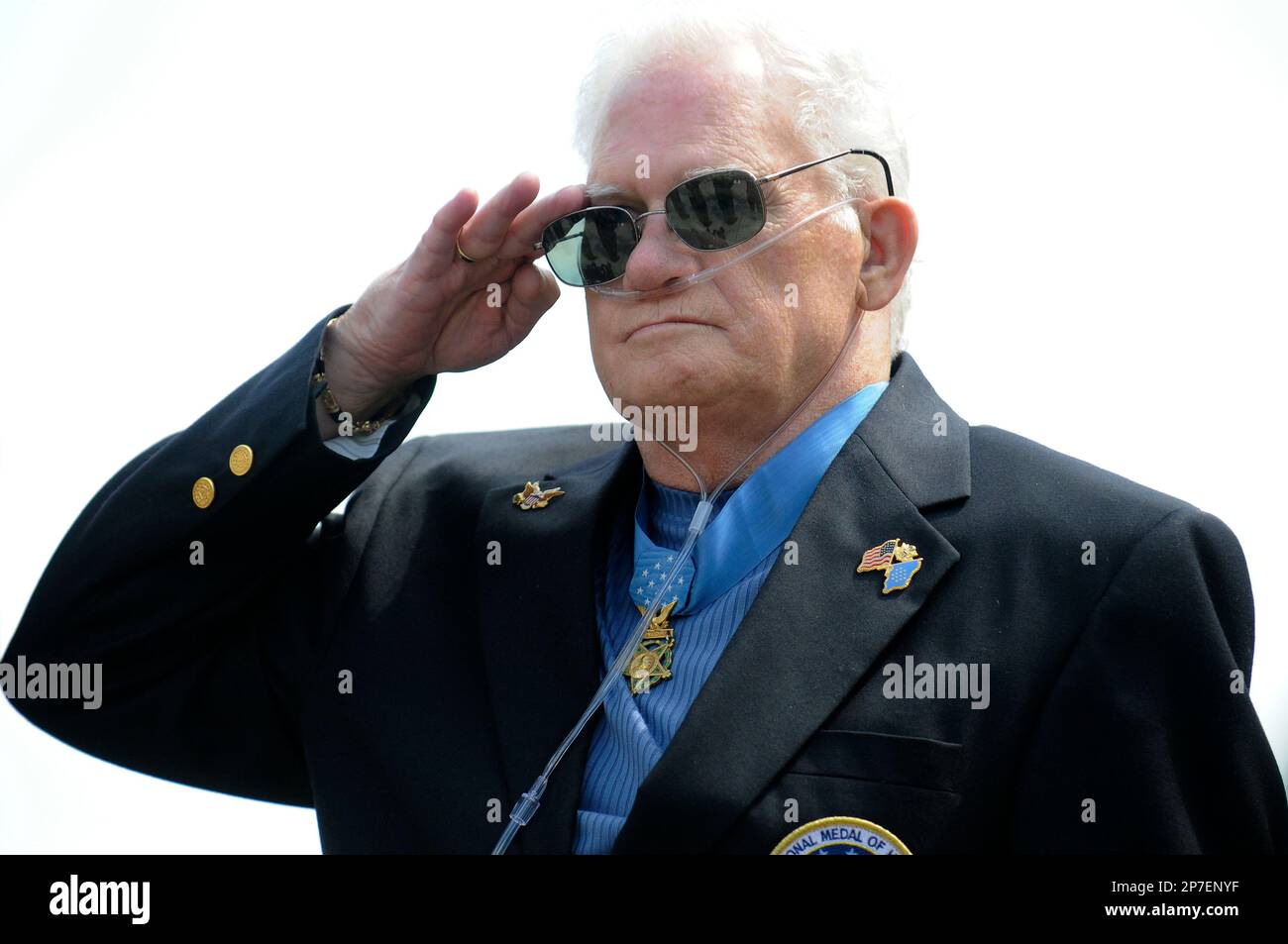 John F. Baker Jr. salutes during the presentation of colors by the ...