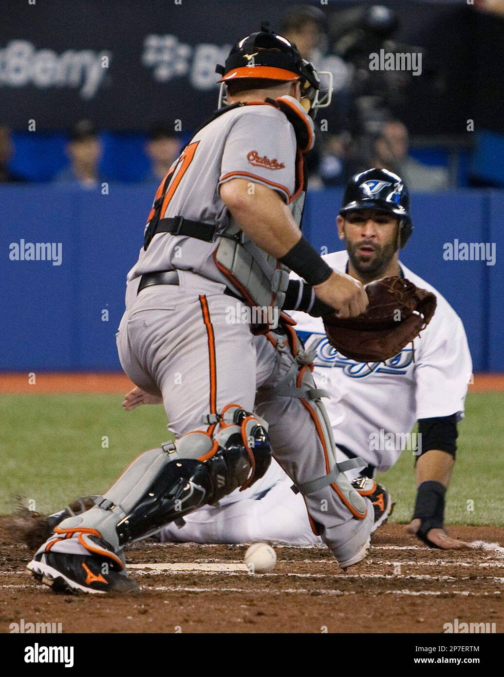 Toronto Blue Jays' Jose Bautista, right, slides in safely to home plate ...