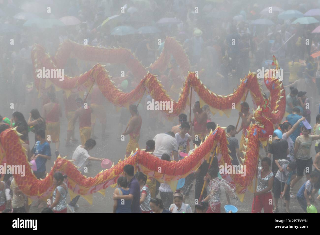 People splash water as artists perform dragon dance to celebrate the ...