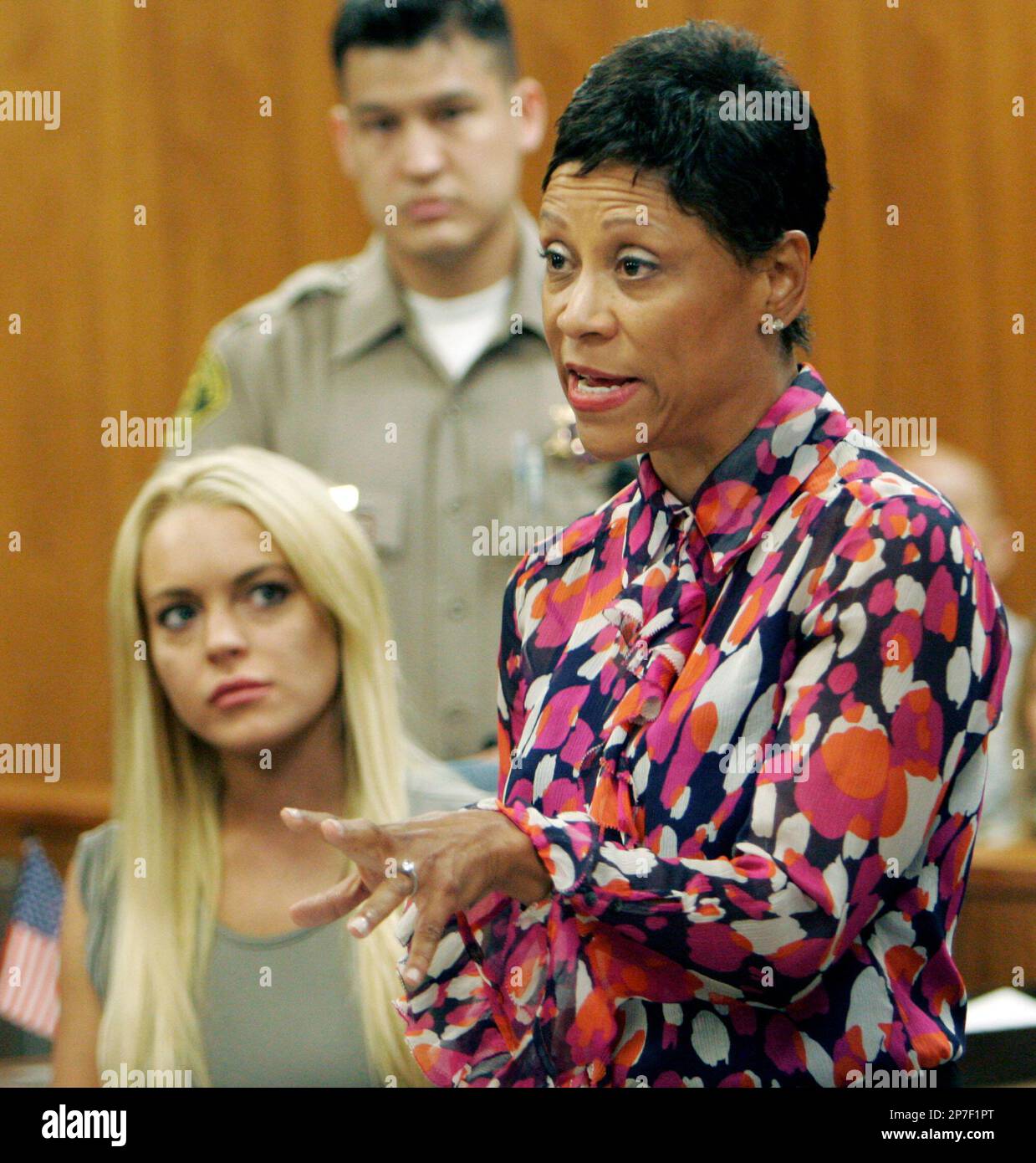Lindsay Lohan, left, looks on as her attorney Shawn Chapman Holley ...
